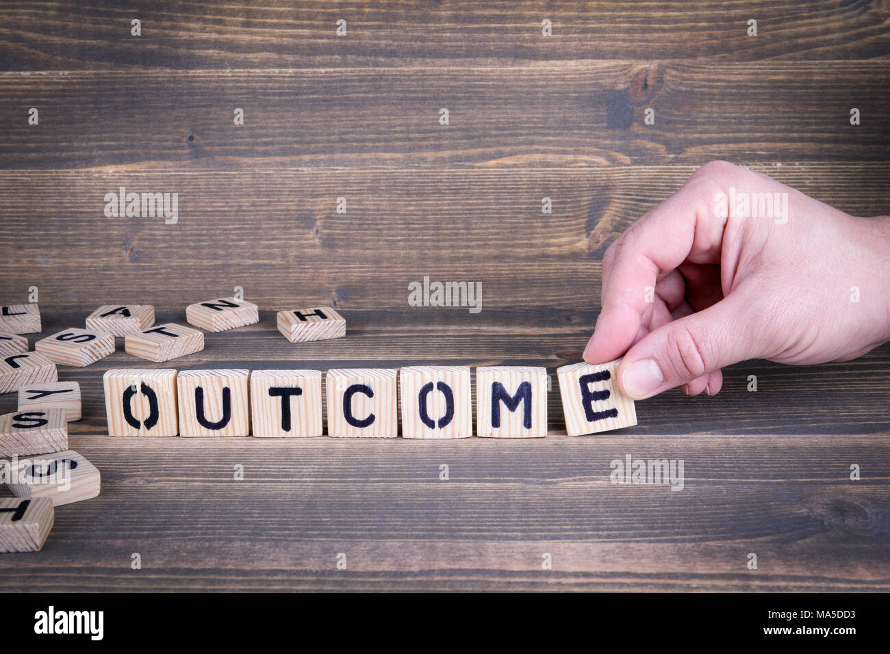 Outcome. Wooden letters on the office desk, informative and ...