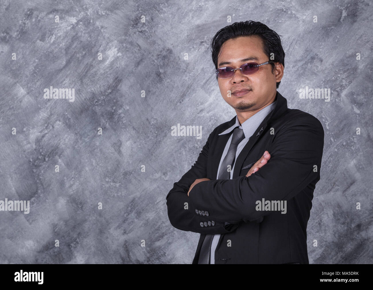 young business man in suit with arms crossed Stock Photo - Alamy