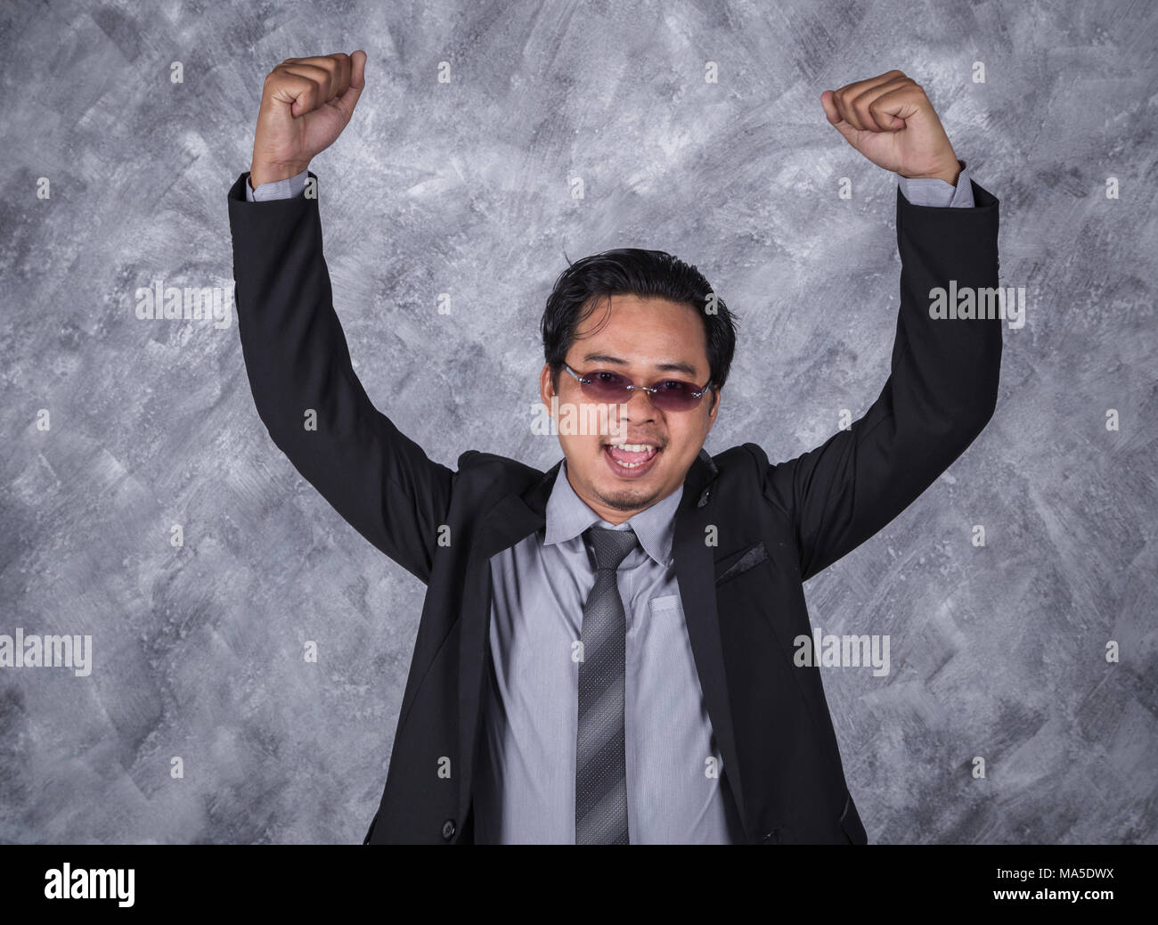 Black man in suit arms up hi-res stock photography and images - Alamy