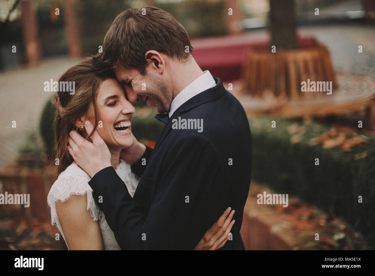 Bridal couple, laughing, hug, standing Stock Photo - Alamy