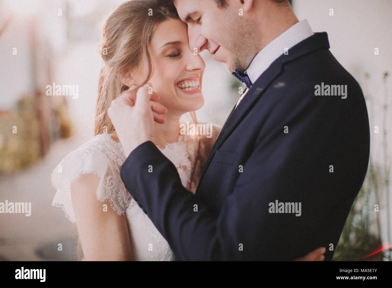 Bridal couple in love, standing, hug, smiling, detail Stock Photo - Alamy