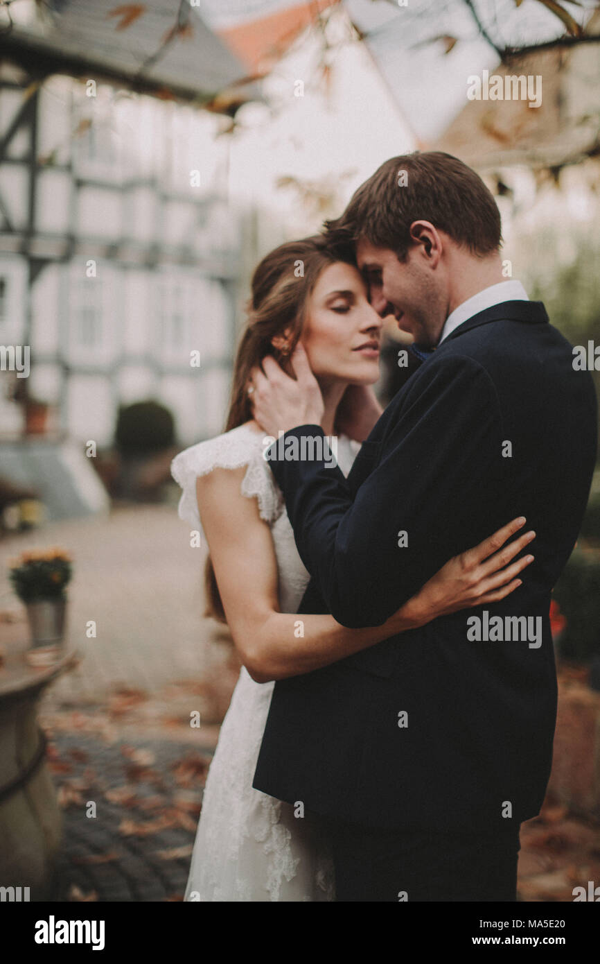 Bridal couple in love, standing, hug Stock Photo - Alamy