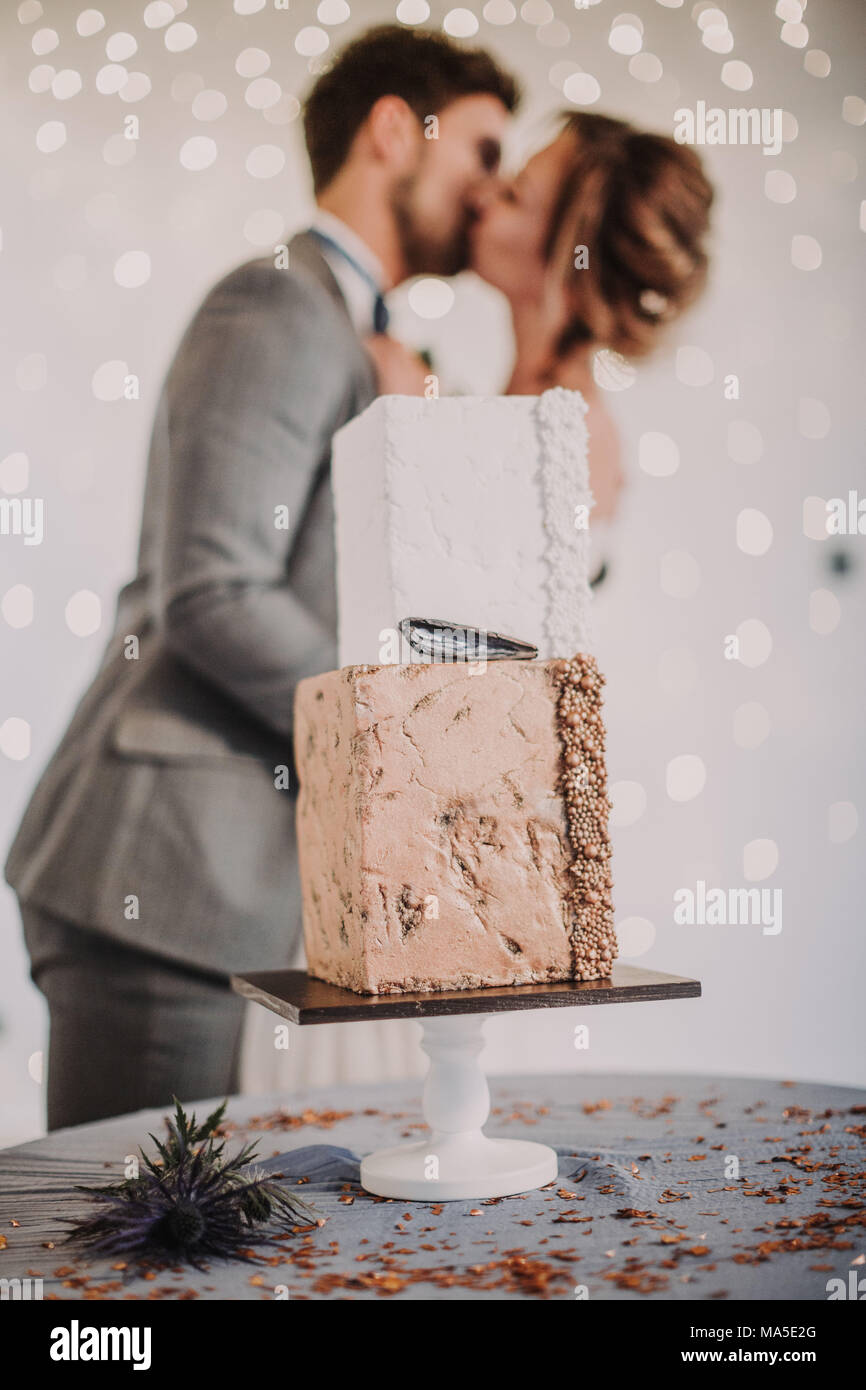 Bridal couple, kiss, table with wedding cake, detail, blur Stock Photo ...