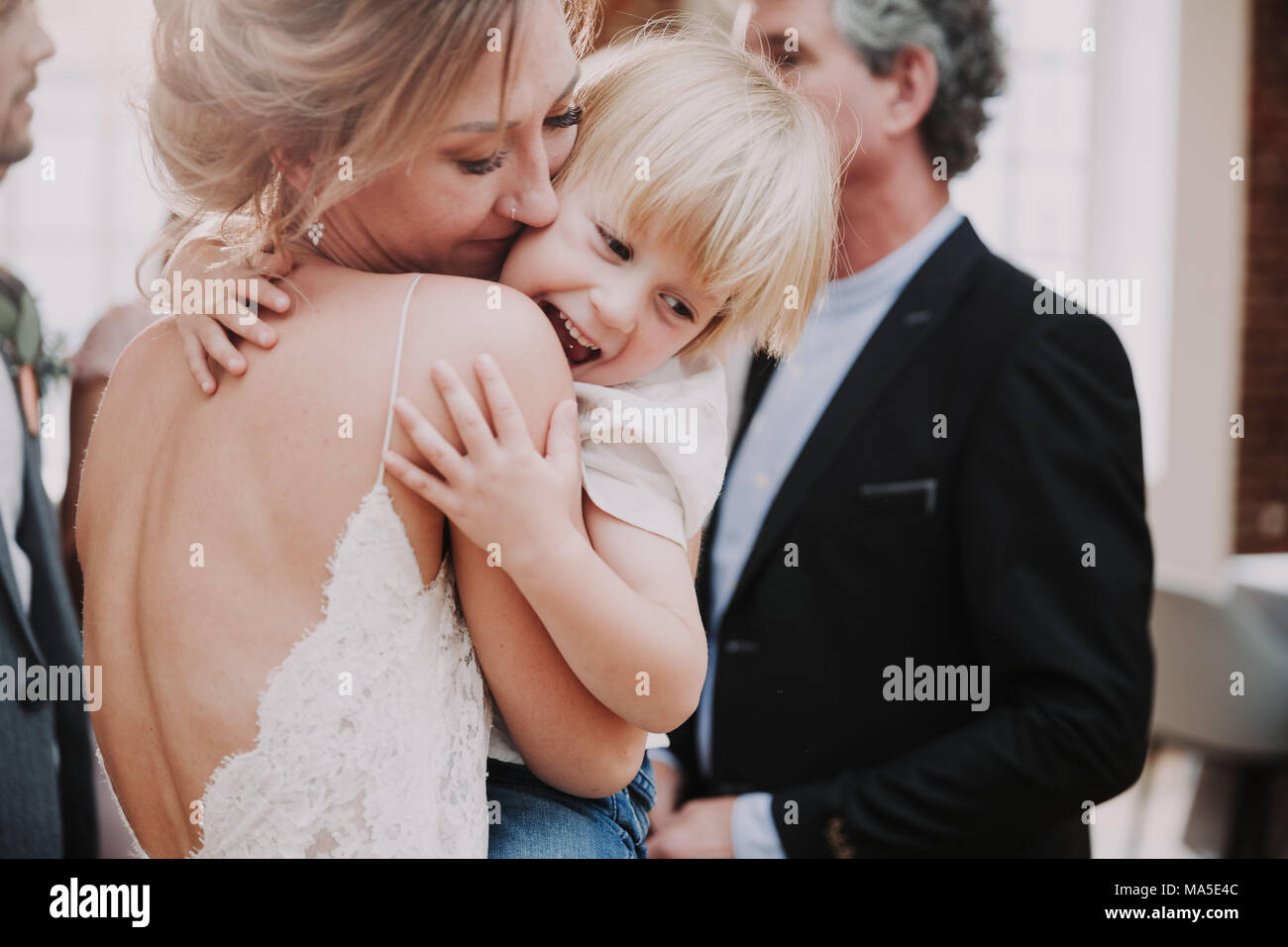 Wedding, bride and boy, hug Stock Photo - Alamy