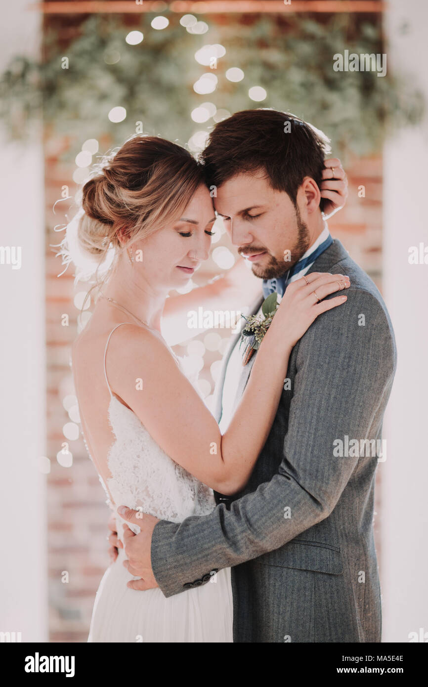 Happy bridal couple, hug, closed eyes, half portrait, side view Stock ...