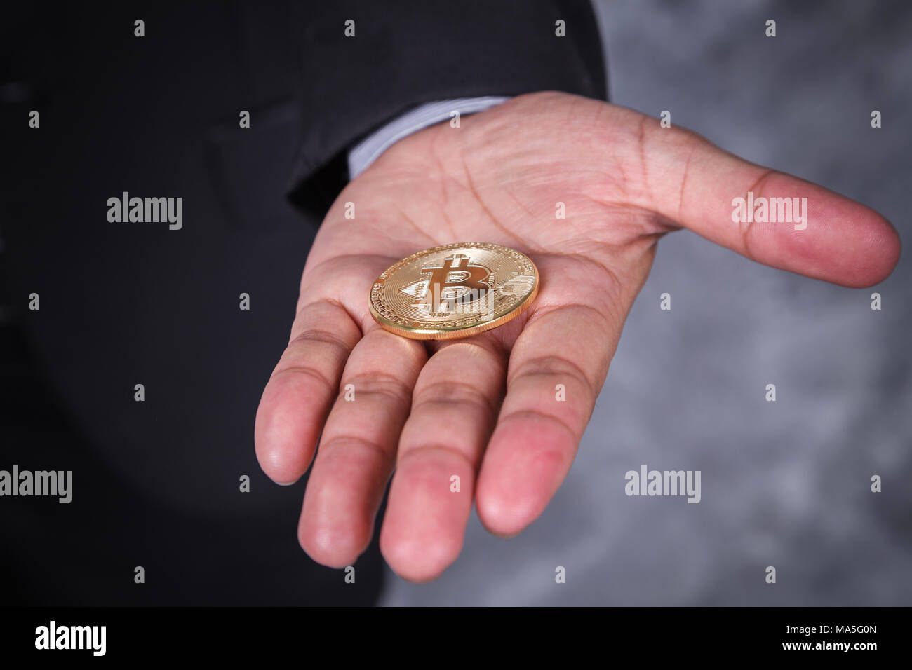 Bitcoin coins in hand hi-res stock photography and images - Alamy