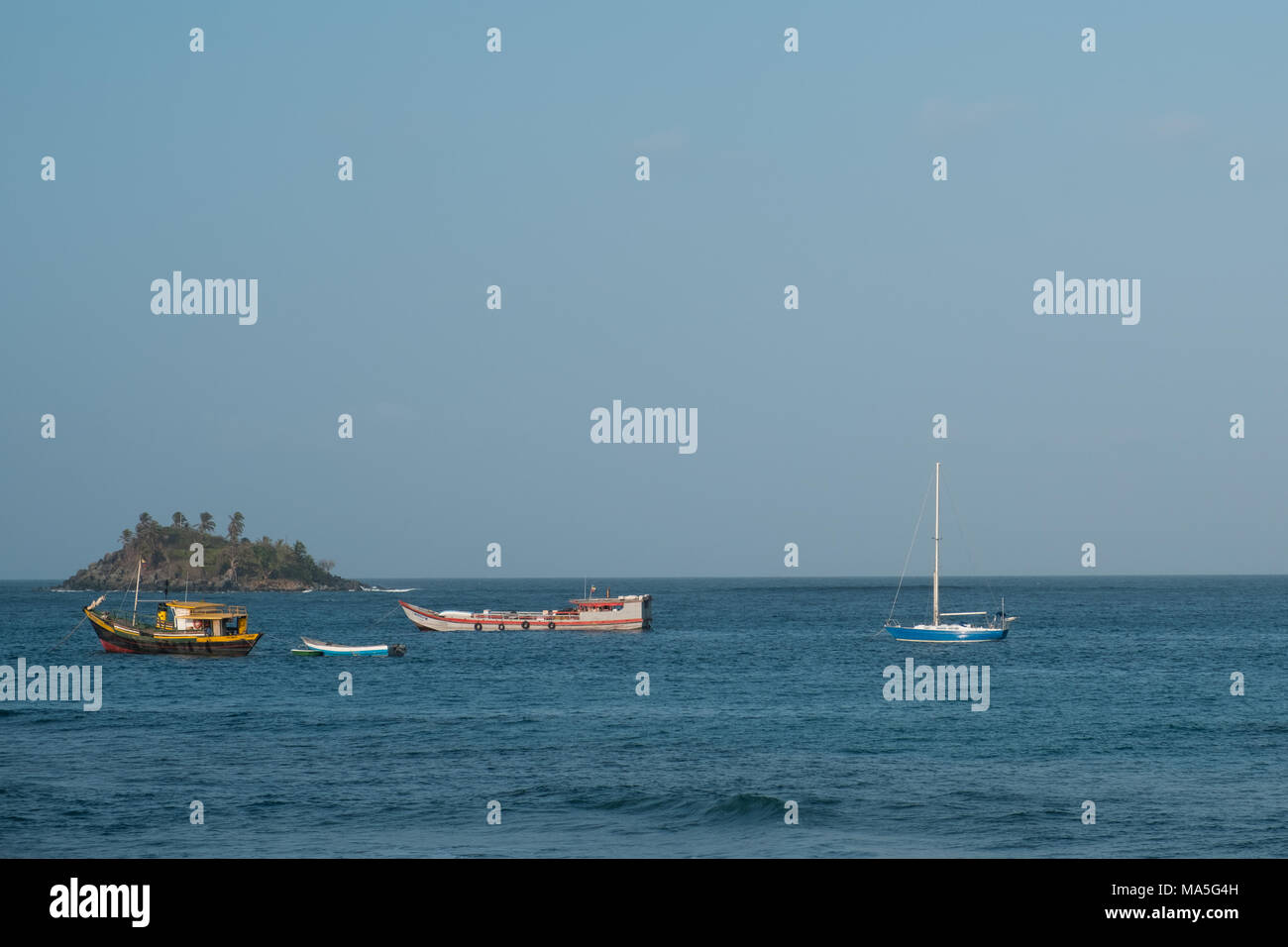 small boats and island ocean horizon - colorful wooden boats Stock ...