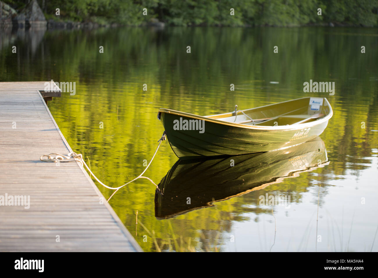 Rowing boat, reflection on the water surface Stock Photo - Alamy