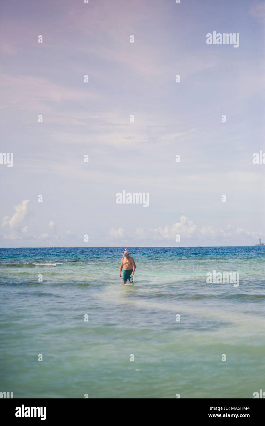 Man walking on the deep turquoise ocean from aruba hi-res stock ...