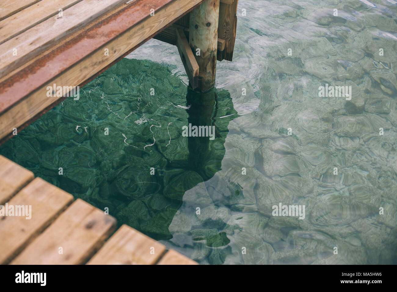 green ocean water close to a beach dock Stock Photo - Alamy