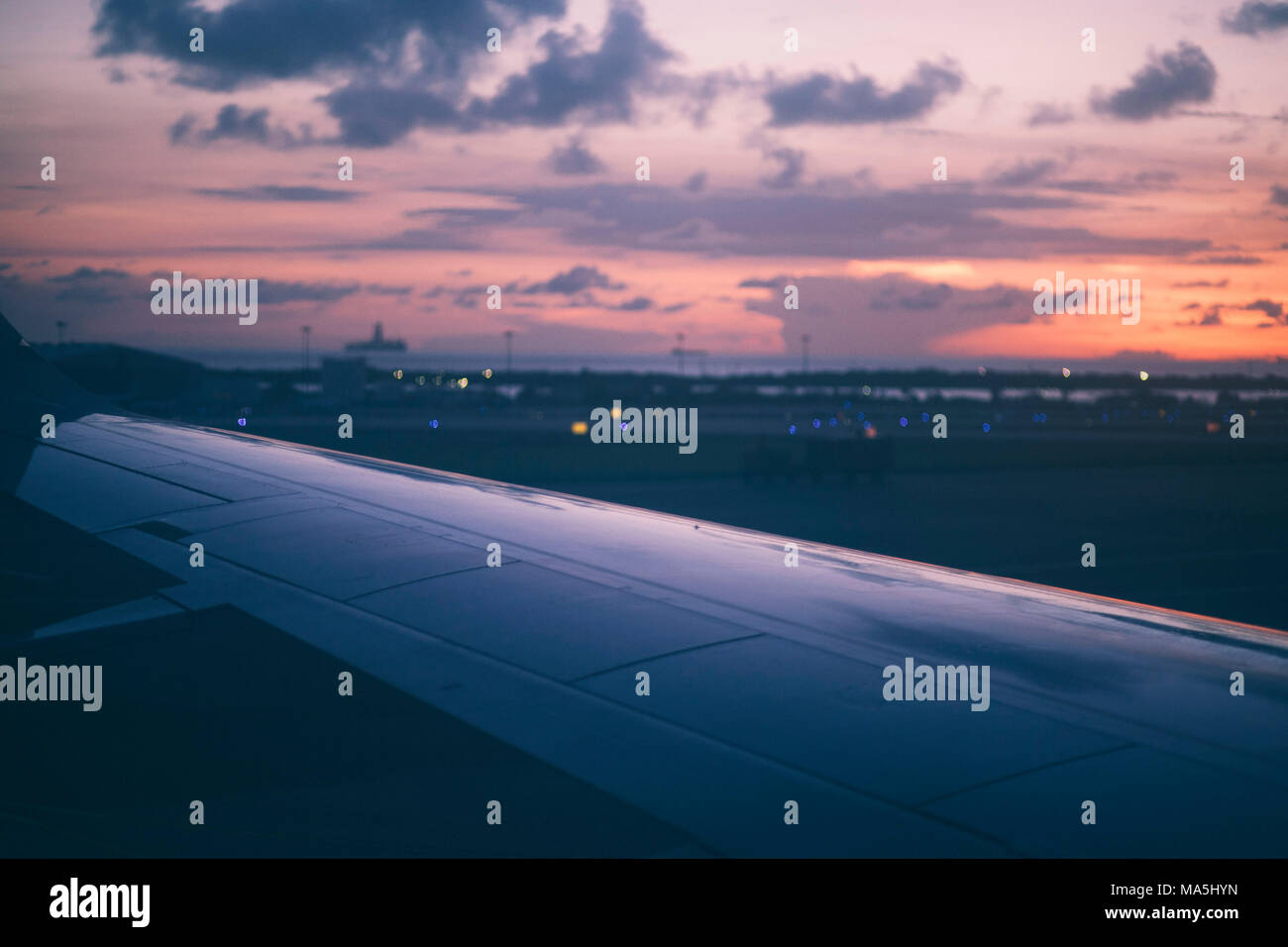 Wing of a plane in a pink sunset hi-res stock photography and images ...