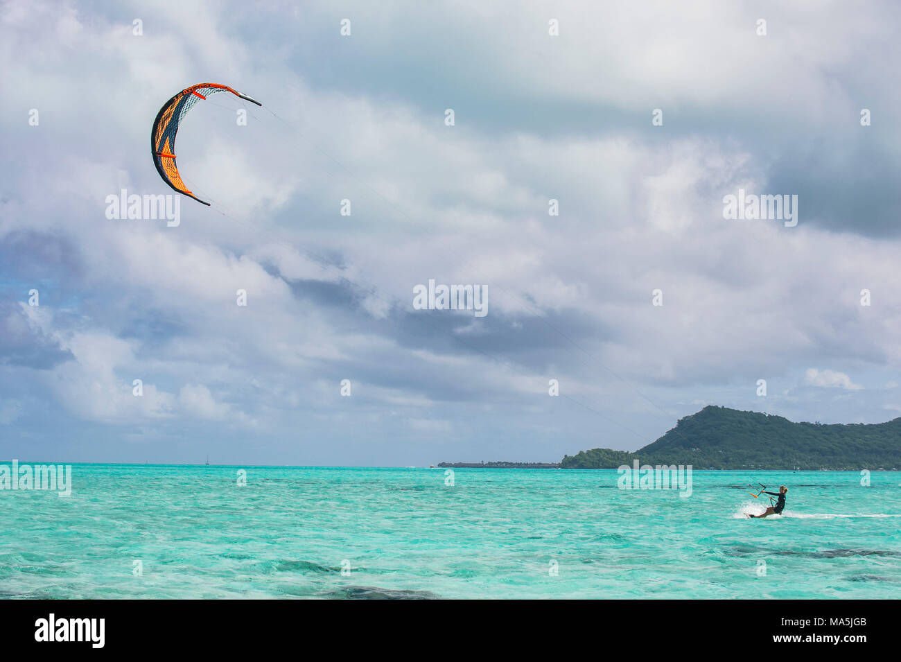 Kitesurfer in the turquoise lagoon of Bora Bora, French Polynesia Stock ...