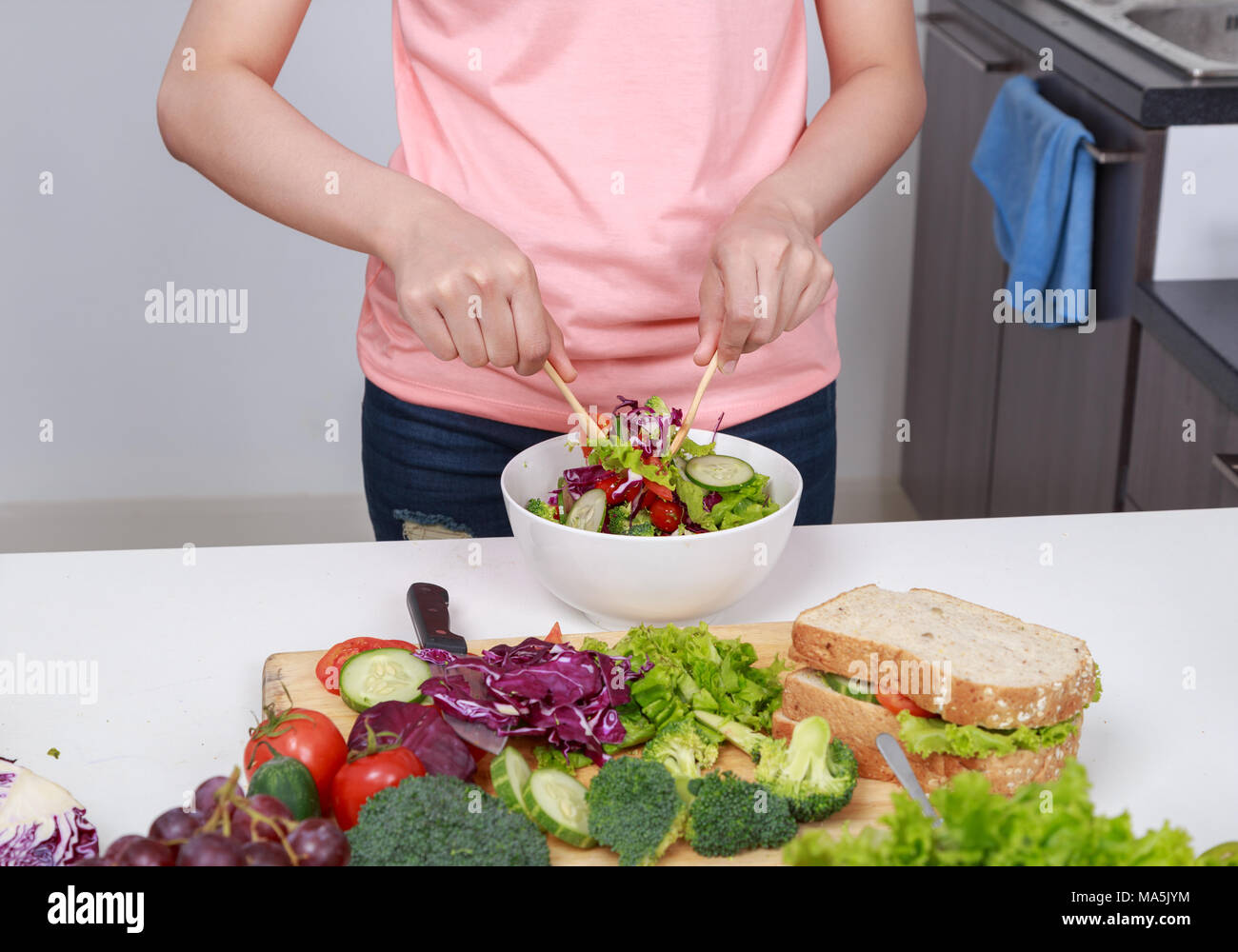 Woman mixing fresh vegetable salad hi-res stock photography and images ...