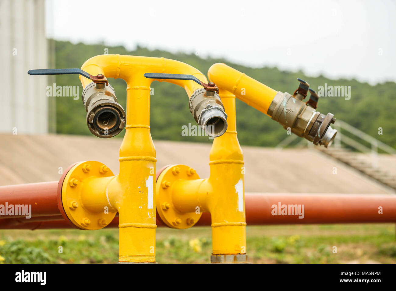 yellow valve water pump and red pipe line Stock Photo - Alamy