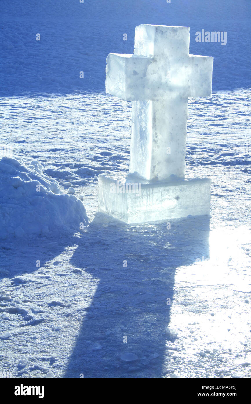 Cross made from ice standing on snow background Stock Photo - Alamy