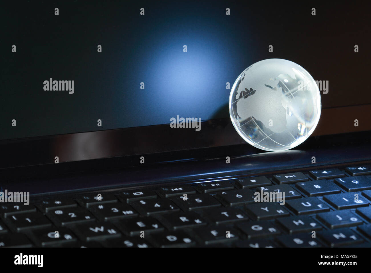 Closeup of glass globe lying on black computer keyboard Stock Photo - Alamy