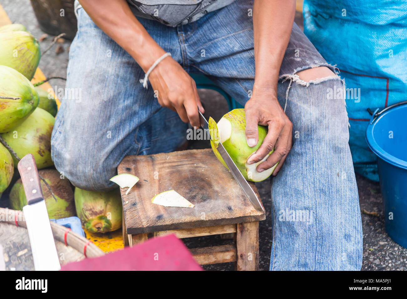 Man cutting coconut hi-res stock photography and images - Alamy