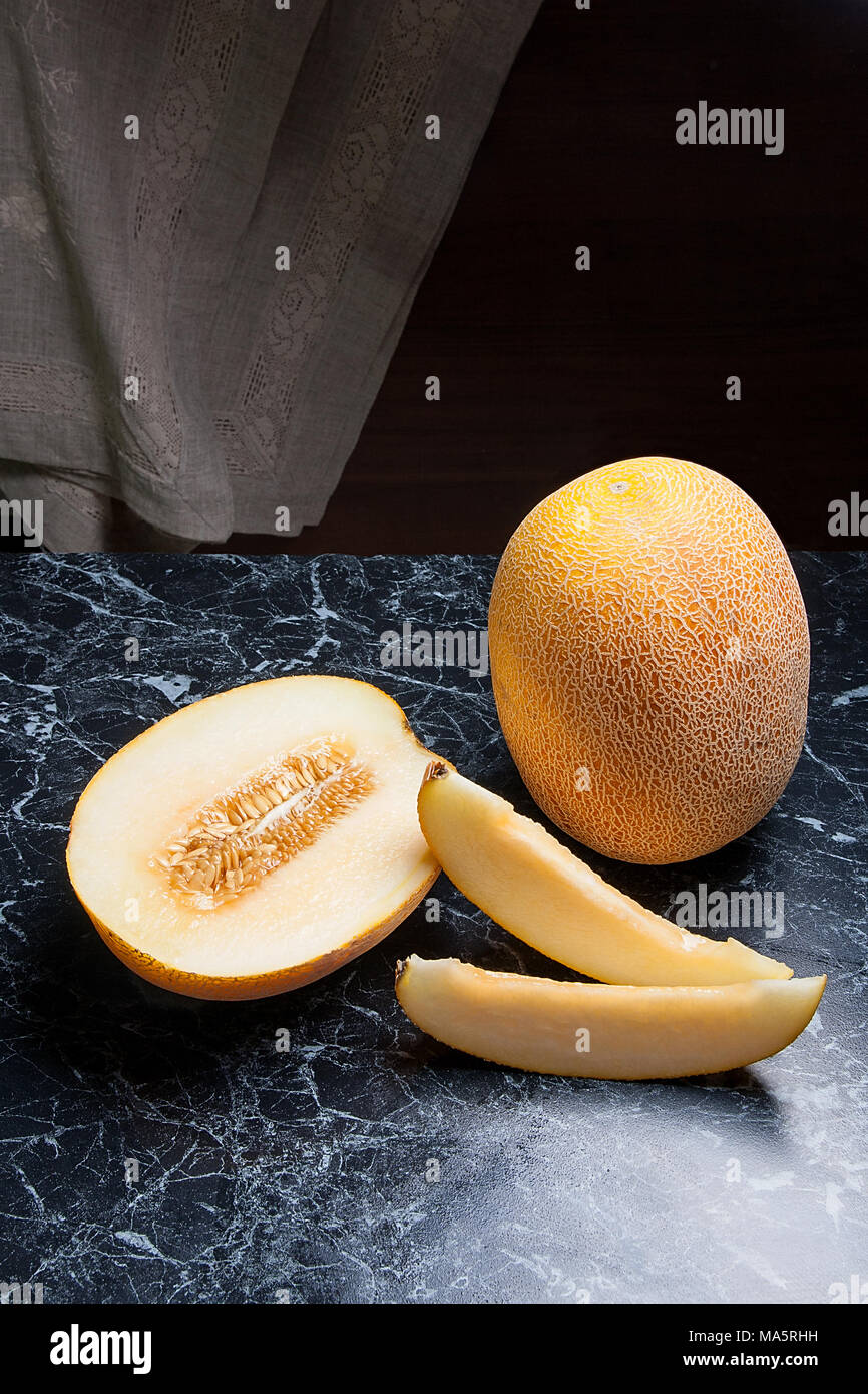 Ripe whole and half honeydew melon fruit at summer time. Sliced ripe ...