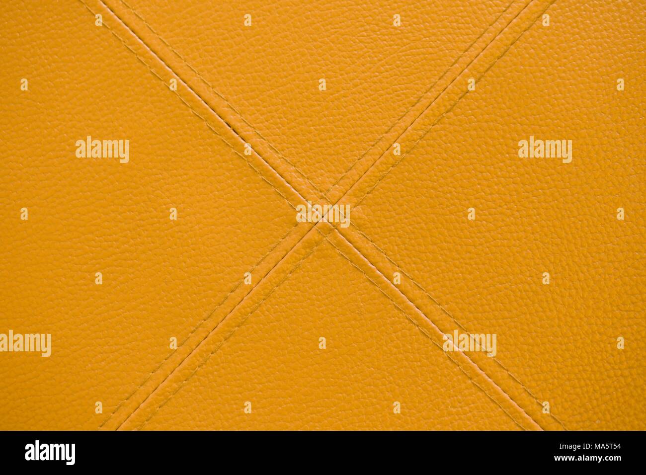 yellow leather with stitch texture and crosswise symbol Stock Photo - Alamy