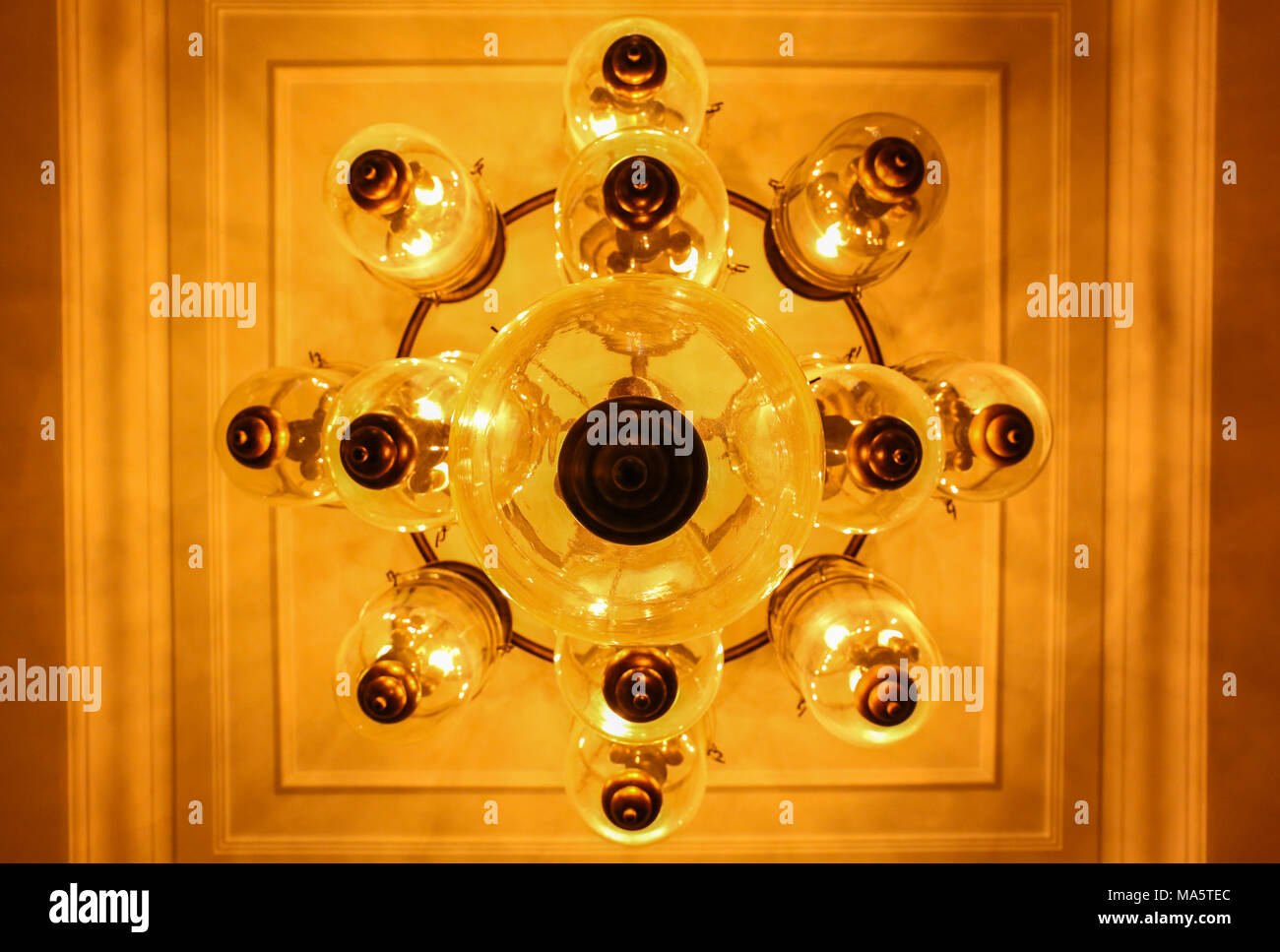 Yellow lamps with glass structure on ceiling in ballroom hi-res stock ...