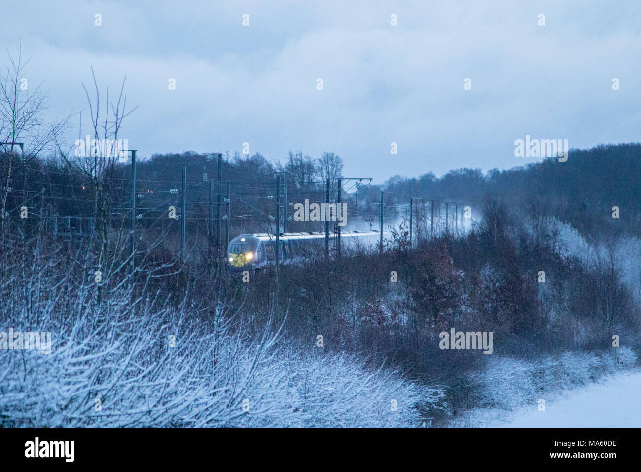 High speed train from Ashford to Ebbsfleet creates snow cloud as it ...