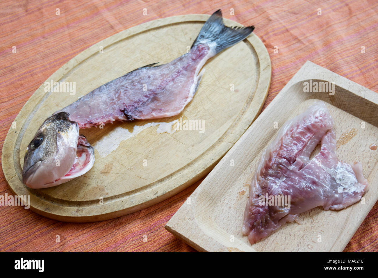 fillet of gilthead just filleted with near the skeleton of the sea ...