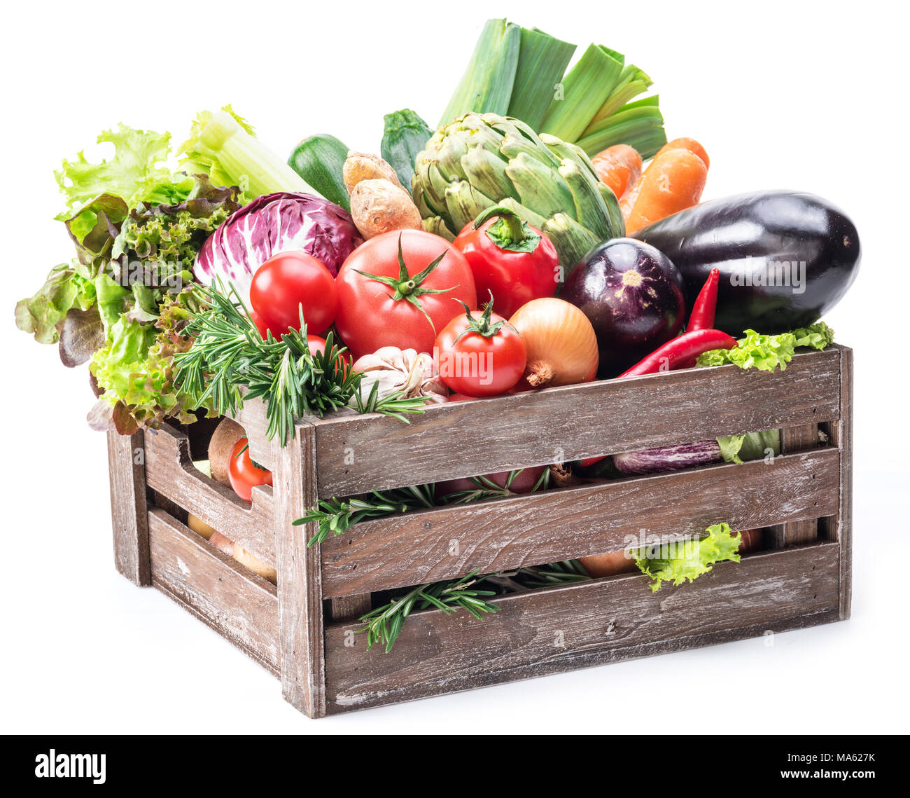Fresh multi-colored vegetables in wooden crate. White background Stock ...