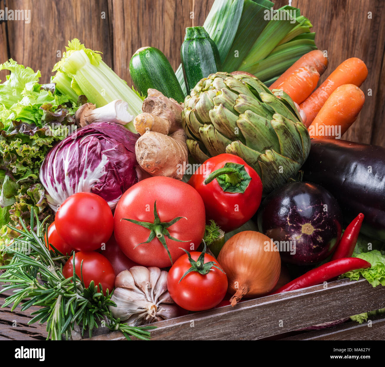 Fresh multi-colored vegetables in wooden crate. Top view Stock Photo ...
