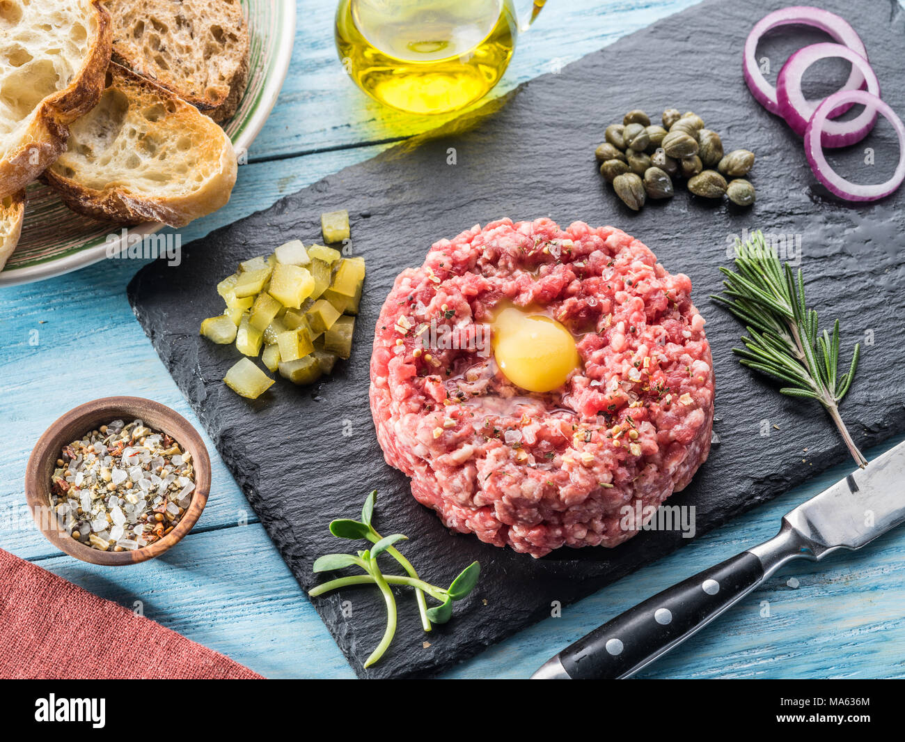 Steak tartare served with raw quail egg yolk, capers and bread. Meat ...