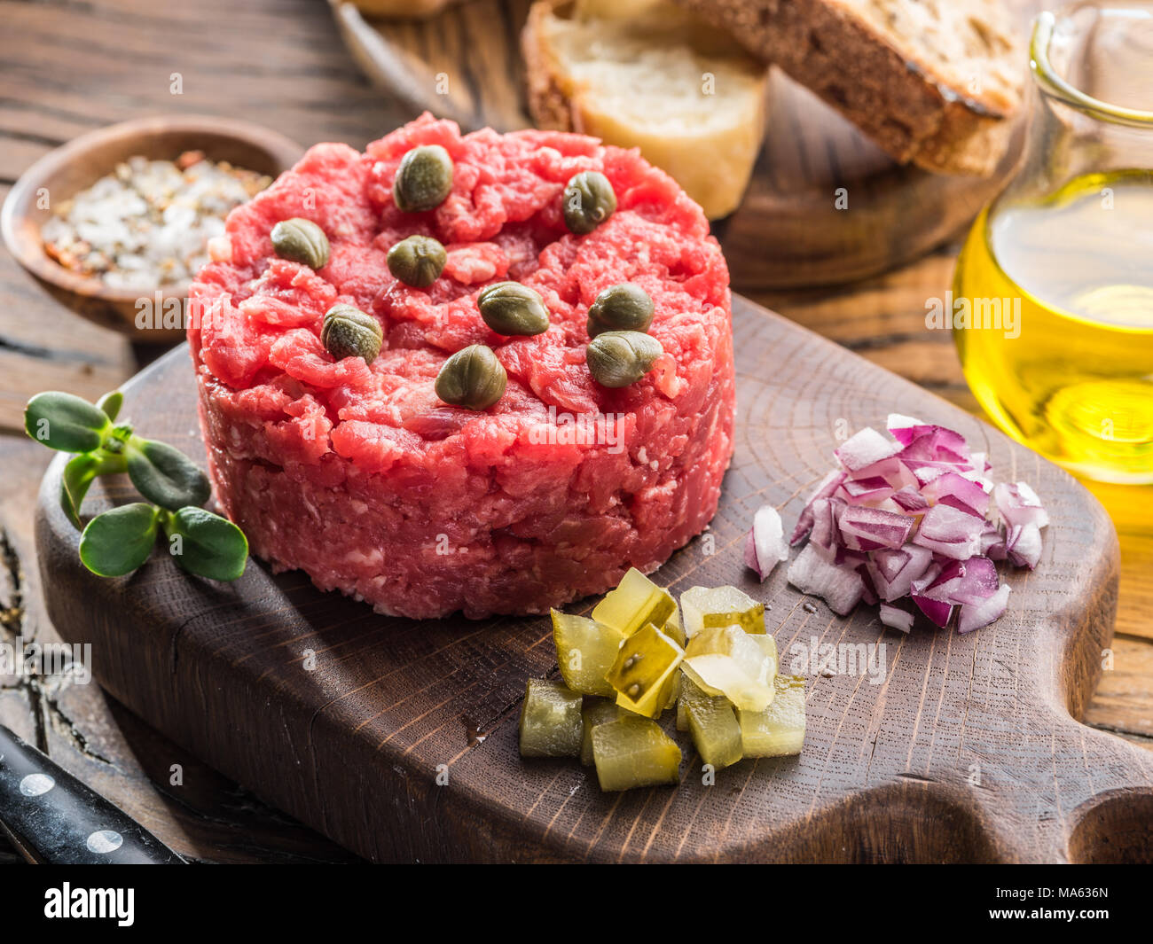 Steak tartare served with capers, pickled cucumbers and chopped onion ...