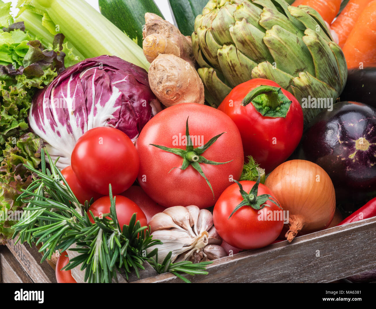 Fresh multi-colored vegetables in wooden crate Stock Photo - Alamy