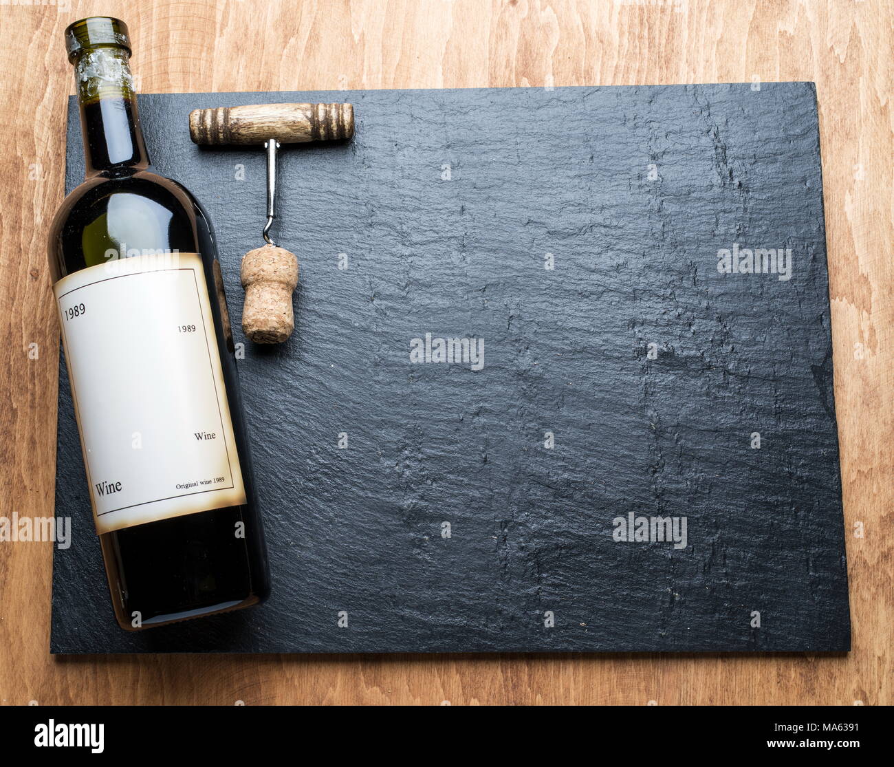 Wine bottle and corkscrew on the graphite board Stock Photo - Alamy