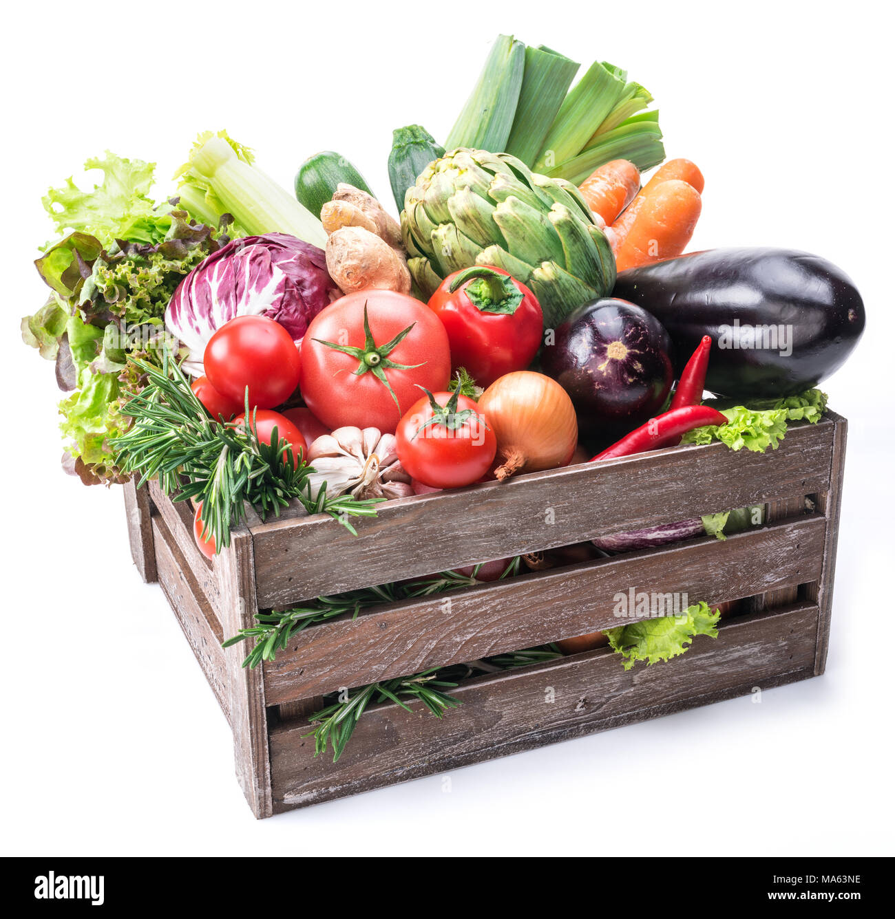 Fresh multi-colored vegetables in wooden crate. White background Stock ...
