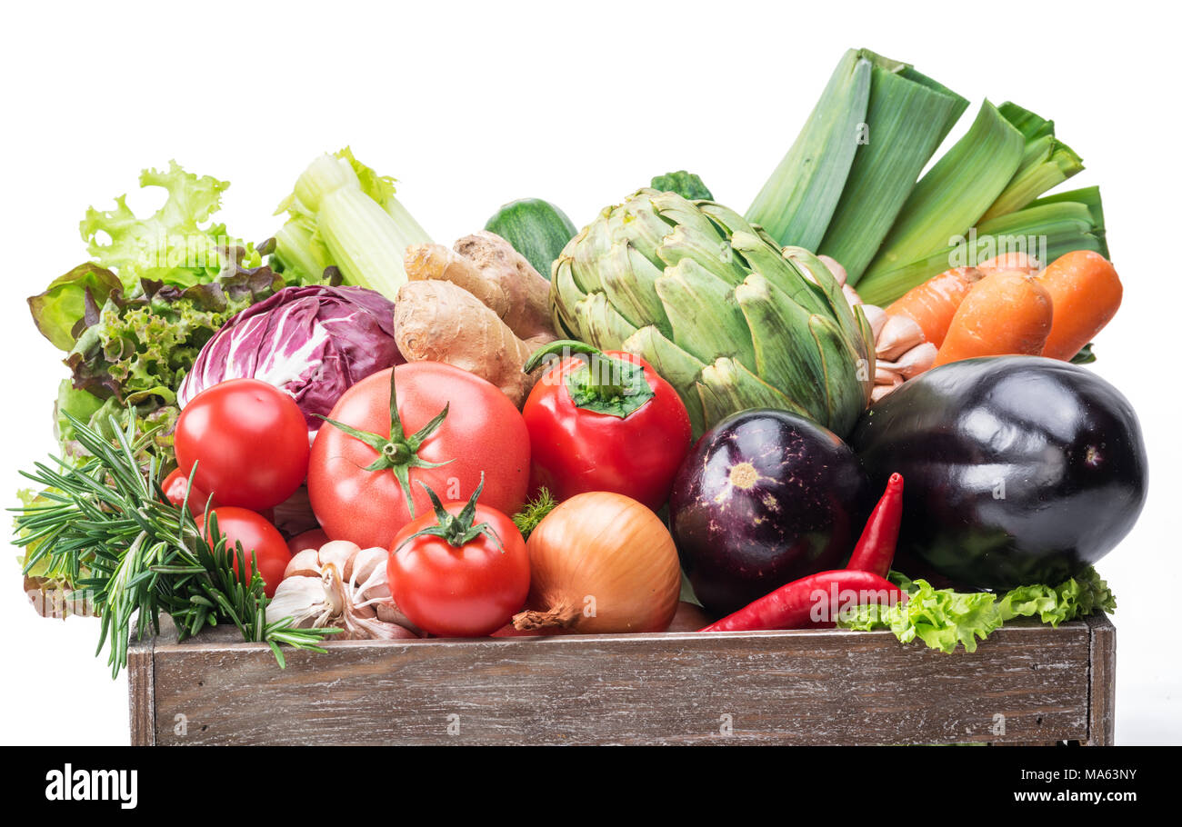 Fresh multi-colored vegetables in wooden crate. White background Stock ...