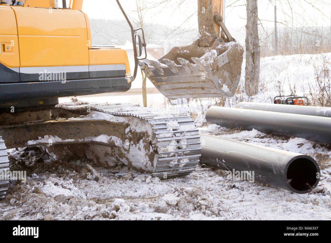 Construction site, excavator wearing metal pipe Stock Photo - Alamy