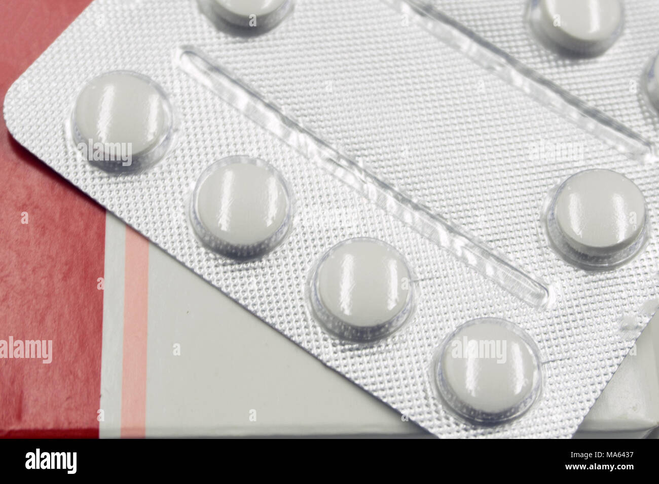 Close container of medicine in tablets on red background Stock Photo ...