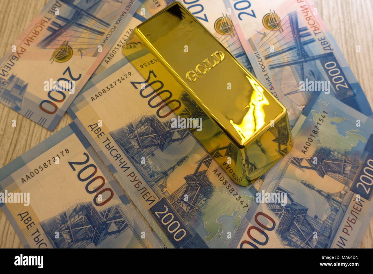 Closeup of golden bullion on hundred dollars banknotes background Stock ...