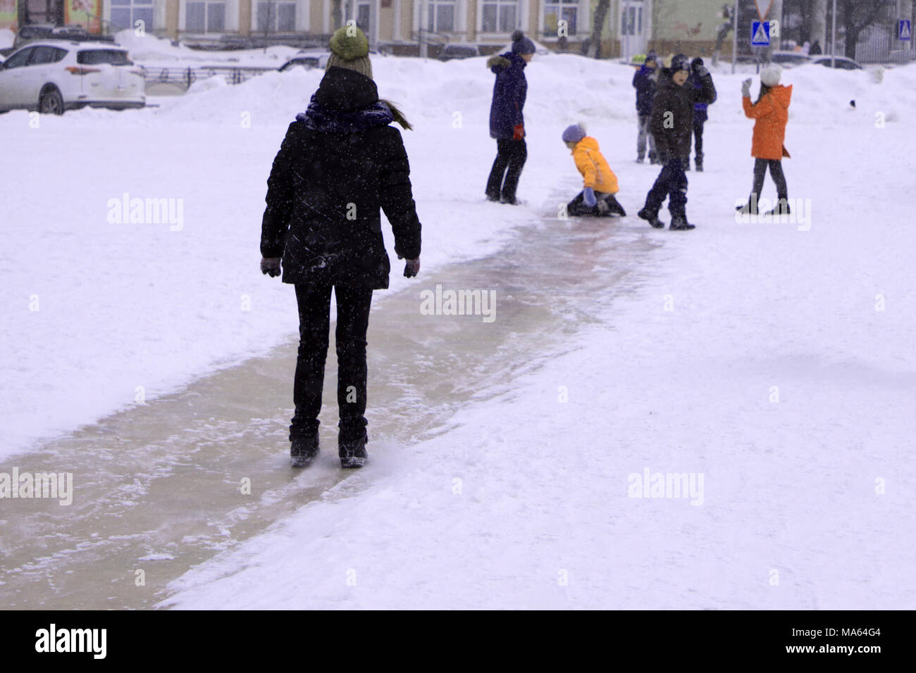 children having fun riding ice slide in winter Stock Photo - Alamy