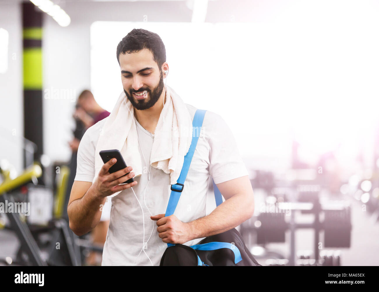 Man in the Gym with Phone Stock Photo - Alamy