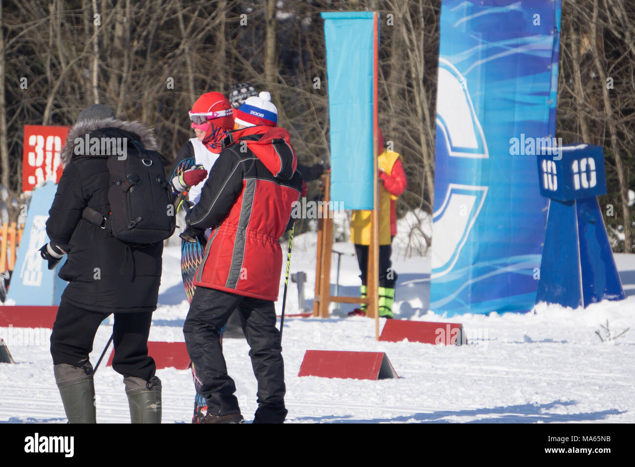 Photographers and judge the skiers at the finish line on the track and ...