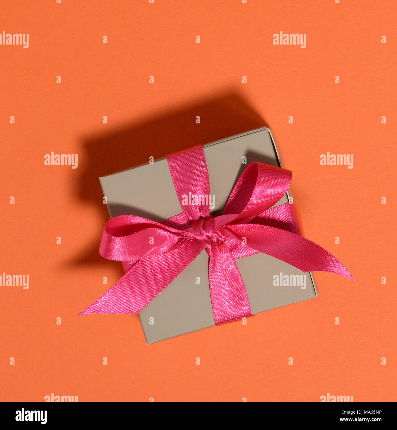 Gift box with tied ribbon bow Stock Photo - Alamy