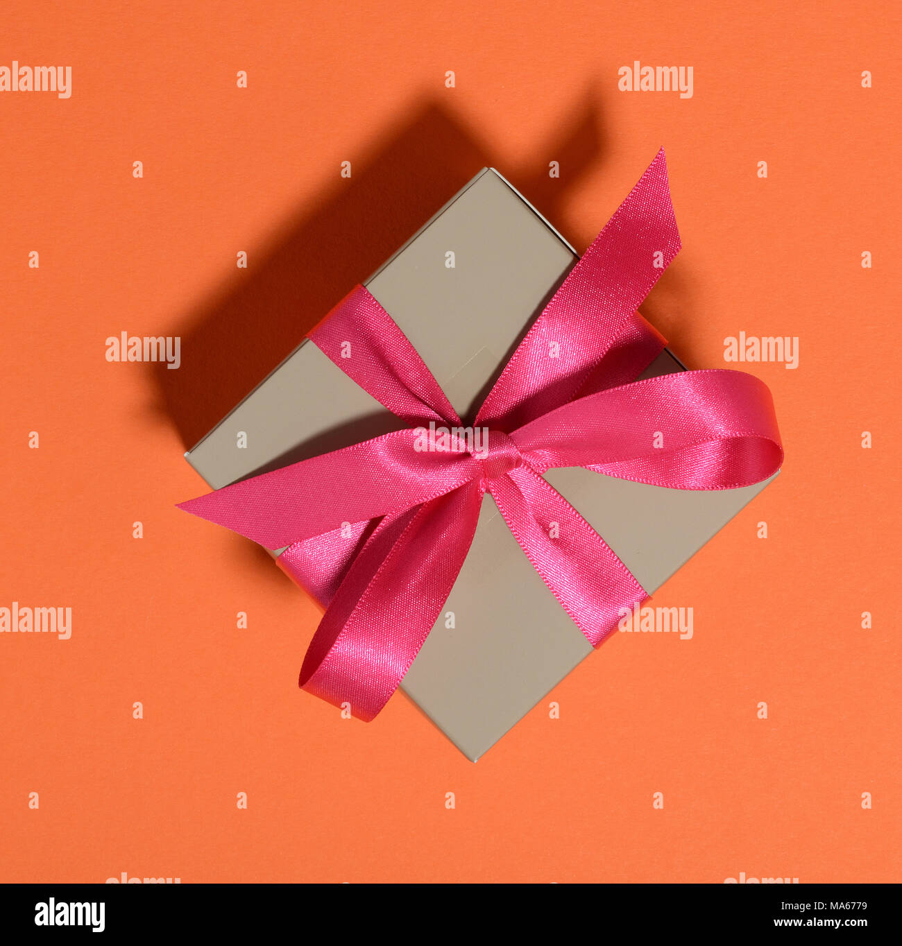 Gift box with tied ribbon bow Stock Photo - Alamy