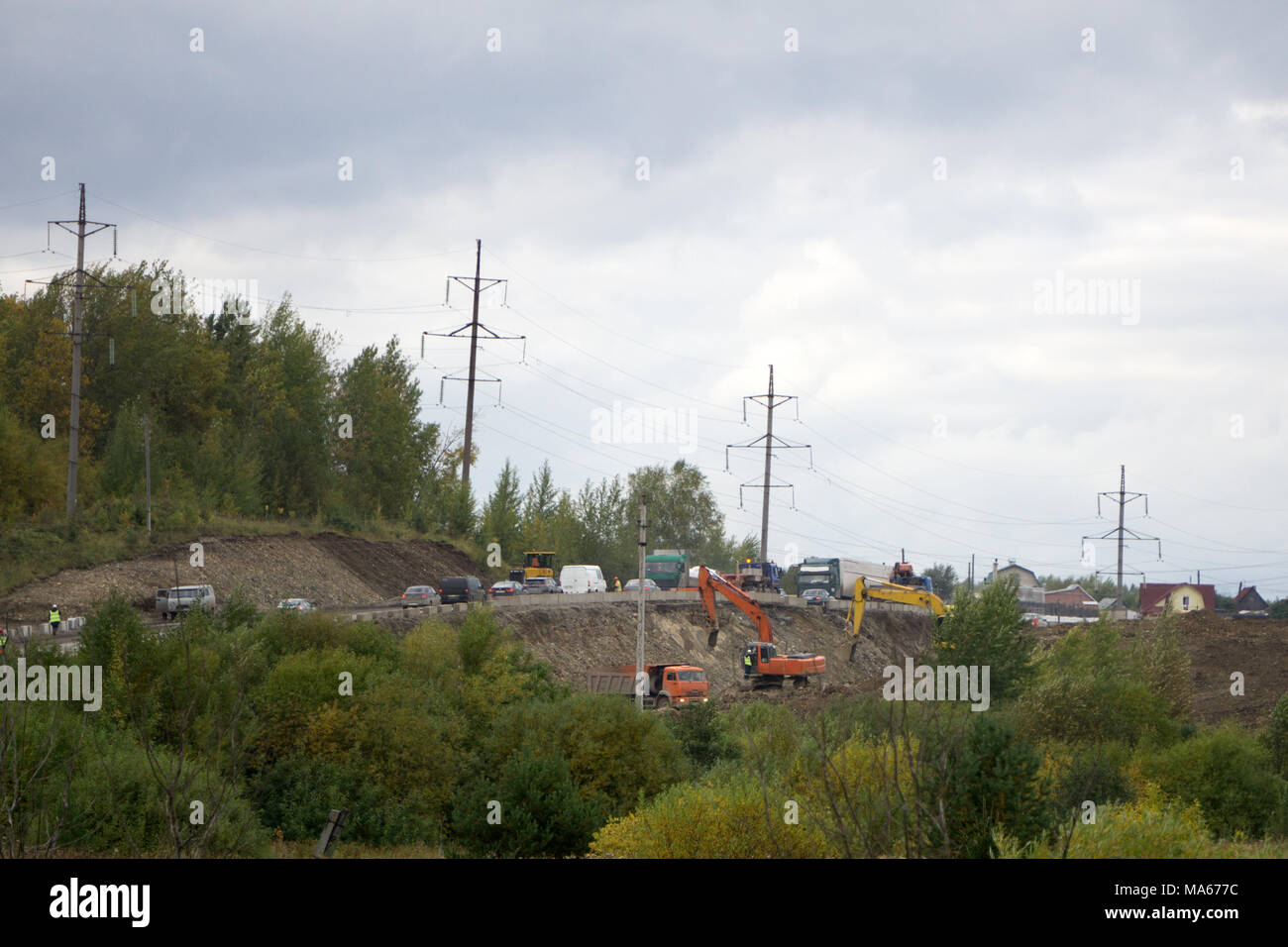 Man is working at the road construction next to an excavator Stock ...
