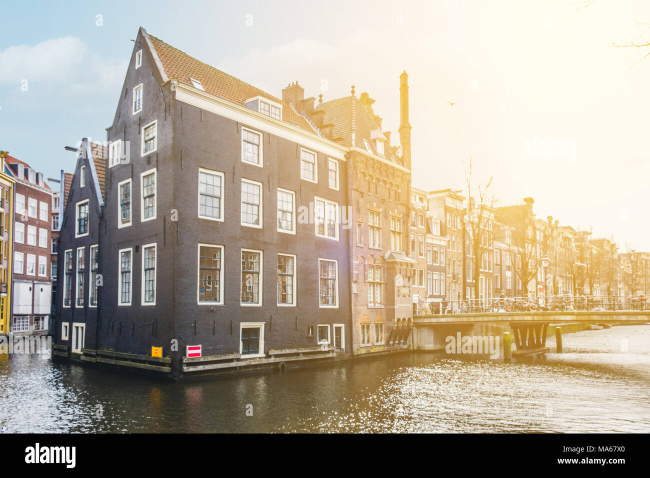 Traditional old building facade in Amsterdam along the canal coast ...