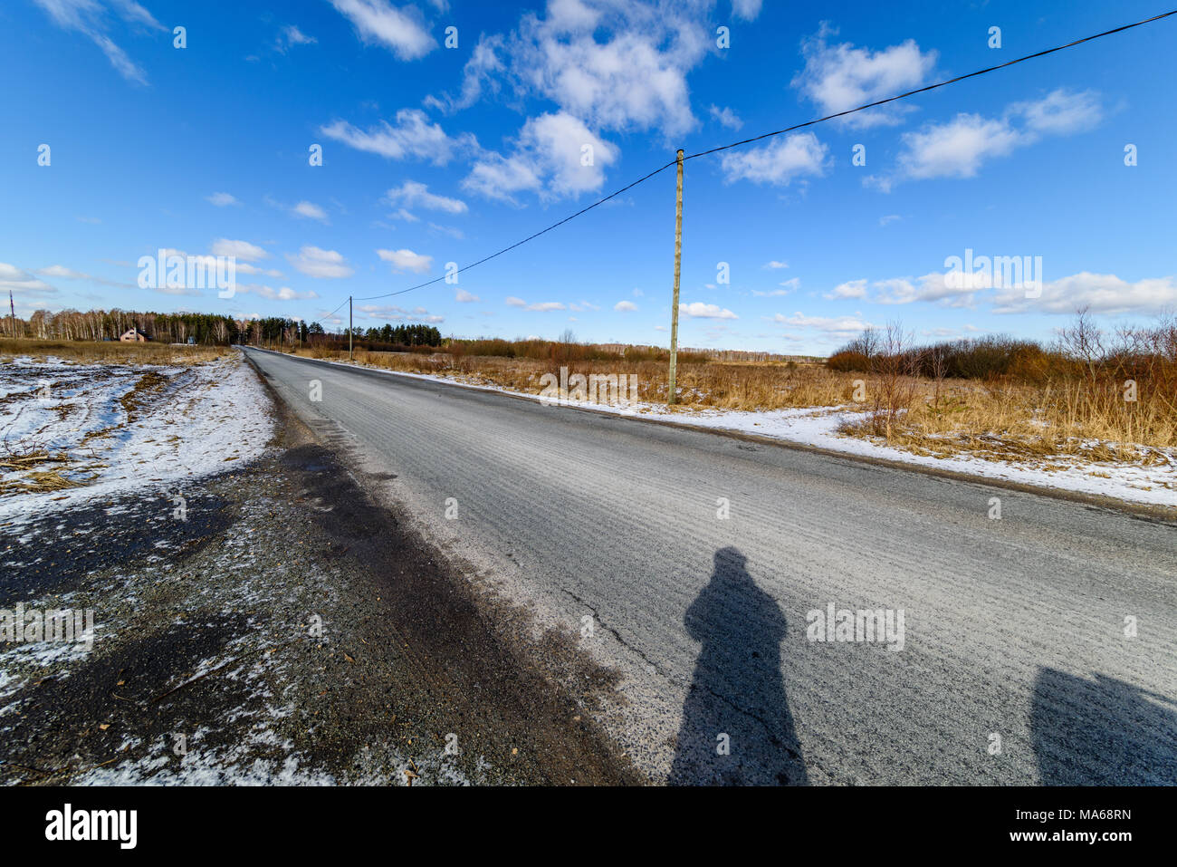snowy winter road covered in deep snow with car tire tracks going in ...
