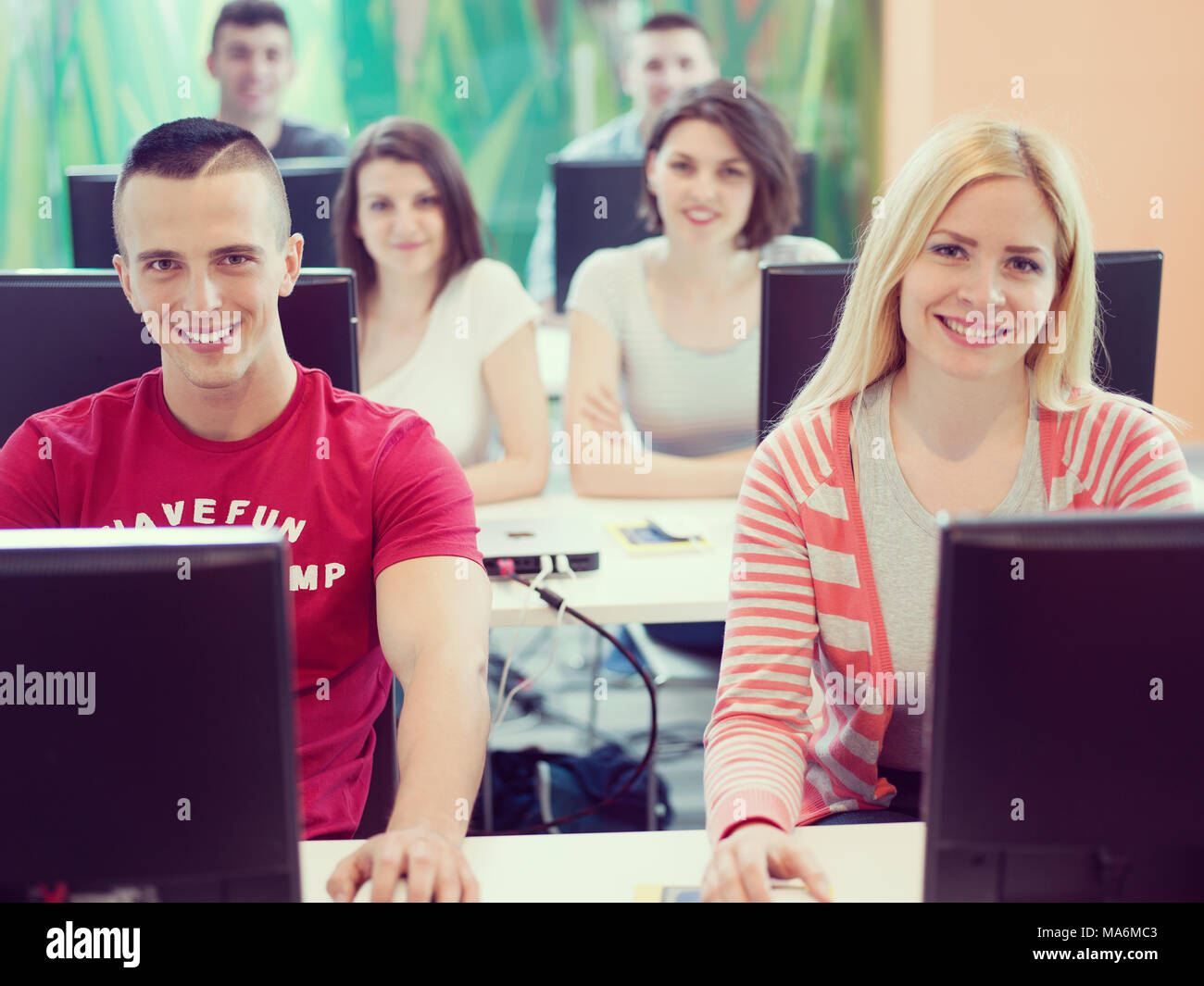 technology students group in computer lab school classroom working on ...