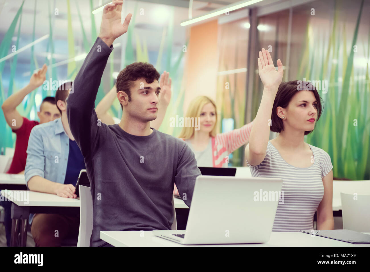 teacher teaching lessons, smart students group raise hands up in school ...