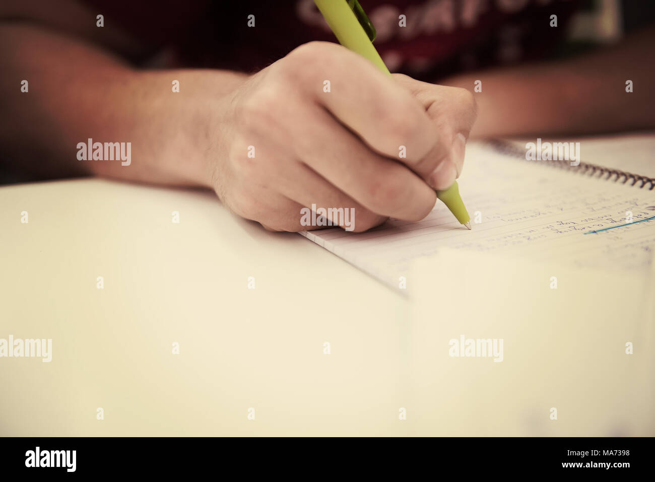 Close up of a student hand underlining a document on a desk at school ...