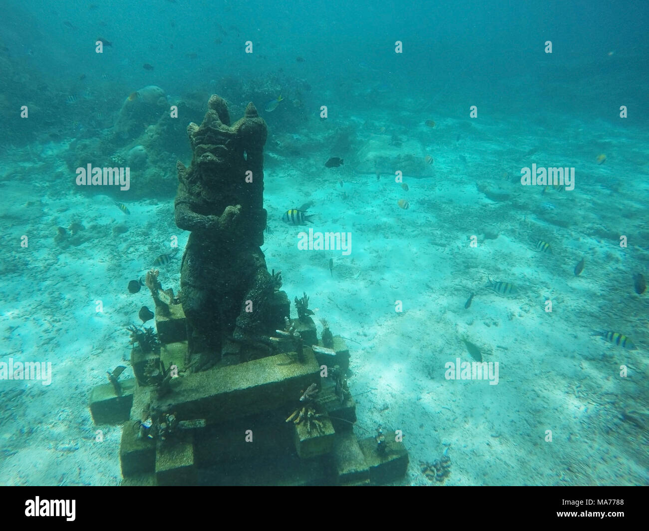 Stone statue standing on sea sandy bottom Stock Photo - Alamy