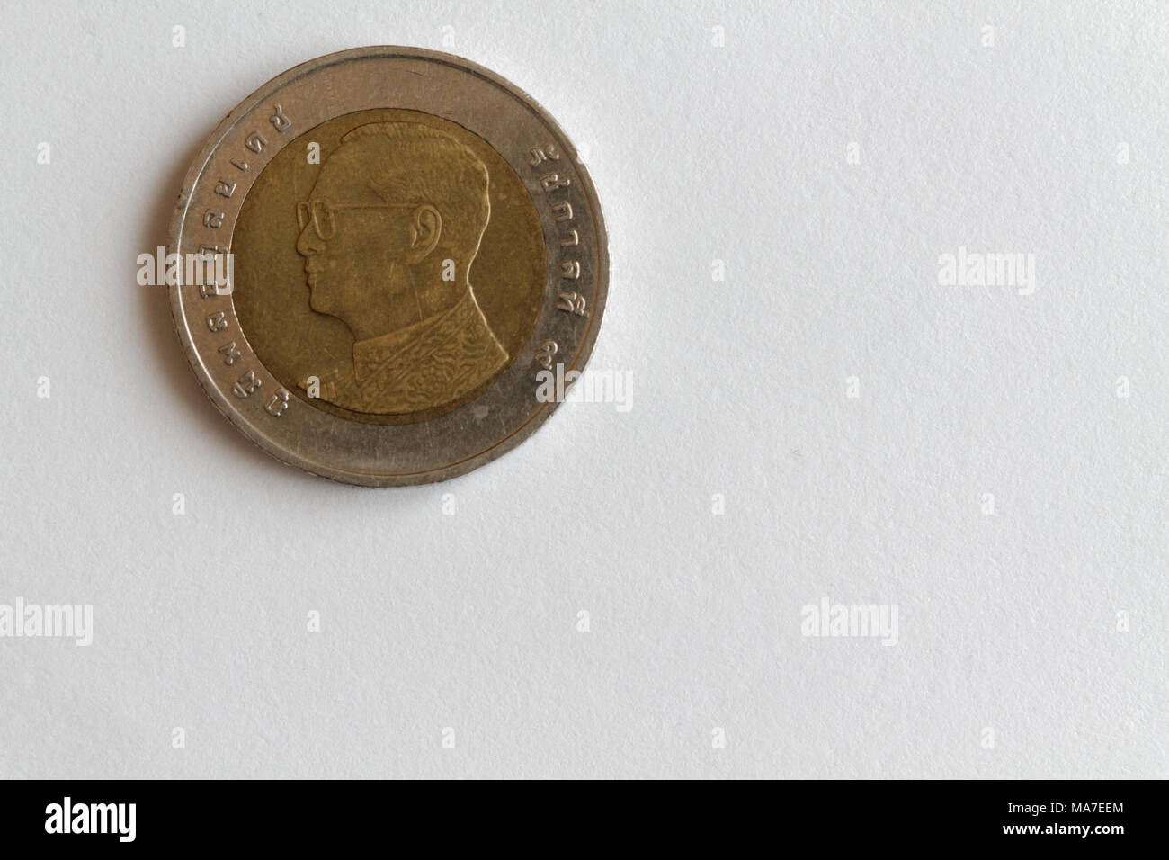 One Thai coin lie on isolated white background Denomination is ten baht ...